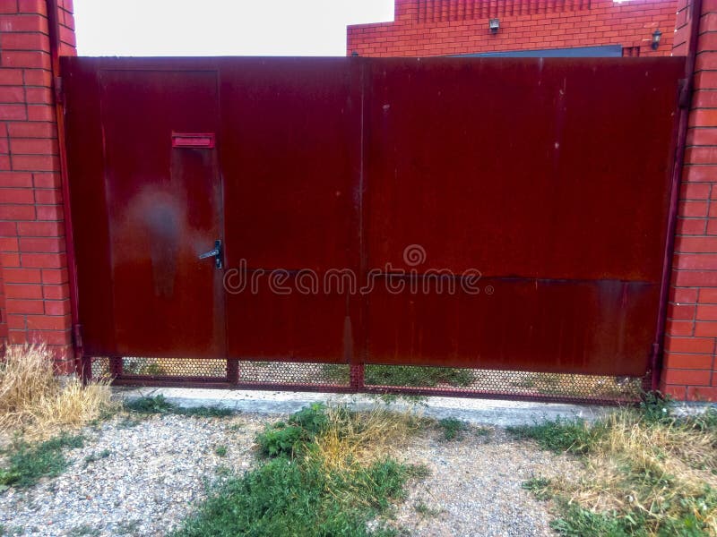 Steel Rusty Gates and a Red Brick Fence. Stock Image - Image of grass ...