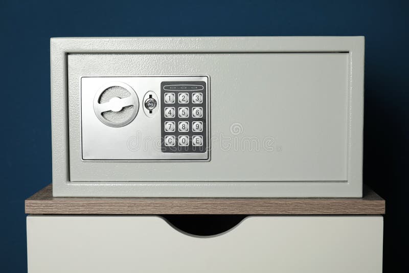 Steel Safe with Electronic Lock on Wooden Table Against Blue Background ...