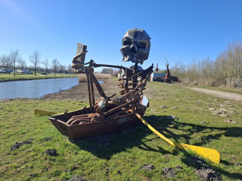 Steel Sculpture of Skeleton in Boat Holding Cell Phone Editorial Photo ...