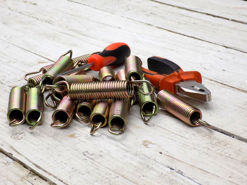 Steel Springs and Tools on a Wooden Table. Stock Image - Image of ...