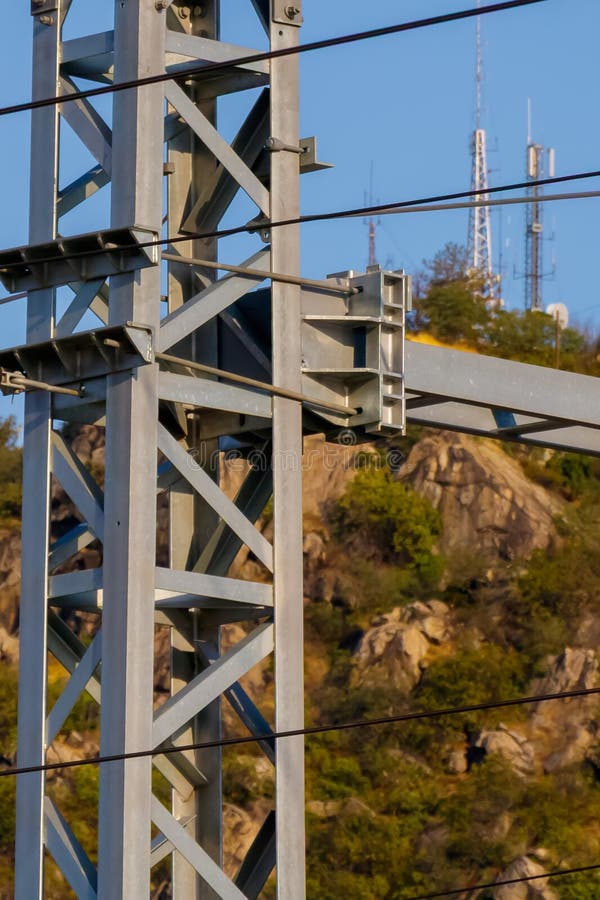 Steel Tower Structure with Electrical Cables and Rocky Hill Background ...