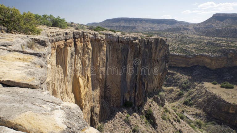 A Steep Cliff Face with Sparse Vegetation in a Remote Desert Landscape Stock Illustration ...