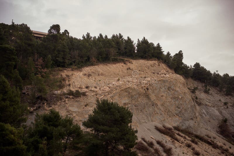 Steep Rocky Hillside with Green Pine Trees Stock Photo - Image of ...