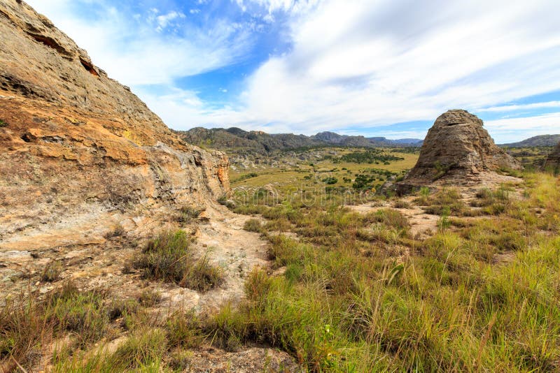 Steep Sharp Rocks Surrounding a Valley with Trees and Grassland Stock ...