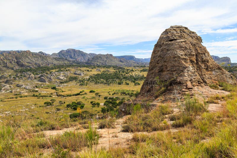 Steep Sharp Rocks Surrounding a Valley with Trees and Grassland Stock ...