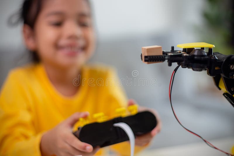 STEM Education Concept. Asian Students Learn at Home by Coding Robot ...