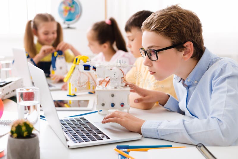 Boy Using Laptop, Assembling Robot in Class Stock Image - Image of ...