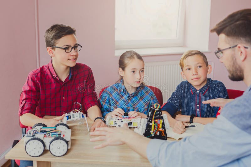Stem Education. Kids Creating Robots with Teacher Stock Photo - Image ... Stem Education. Kids Creating Robots with Teacher Stock Photo - Image ...