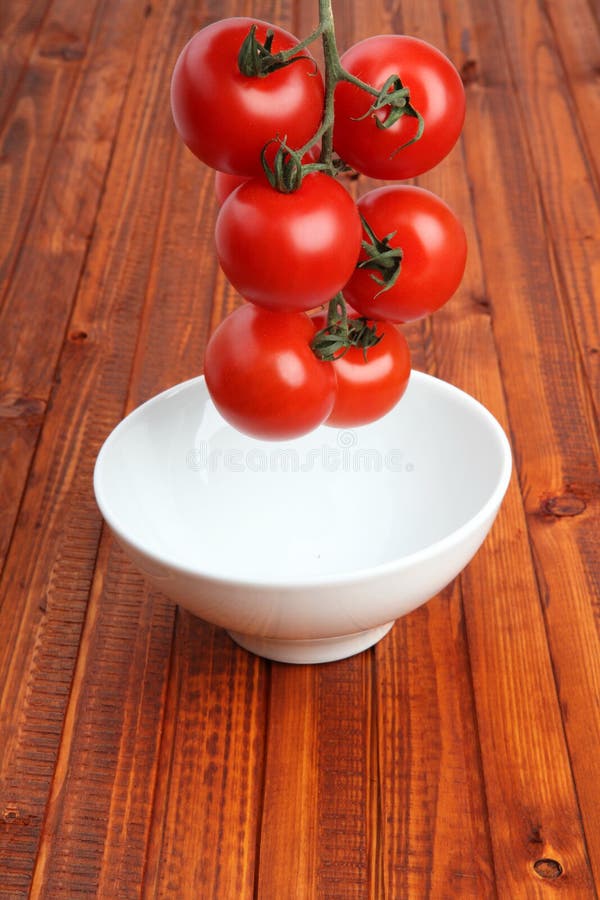 Stem of Tomatoes Pulled Down into a Bowl by Gravity Stock Image - Image ...