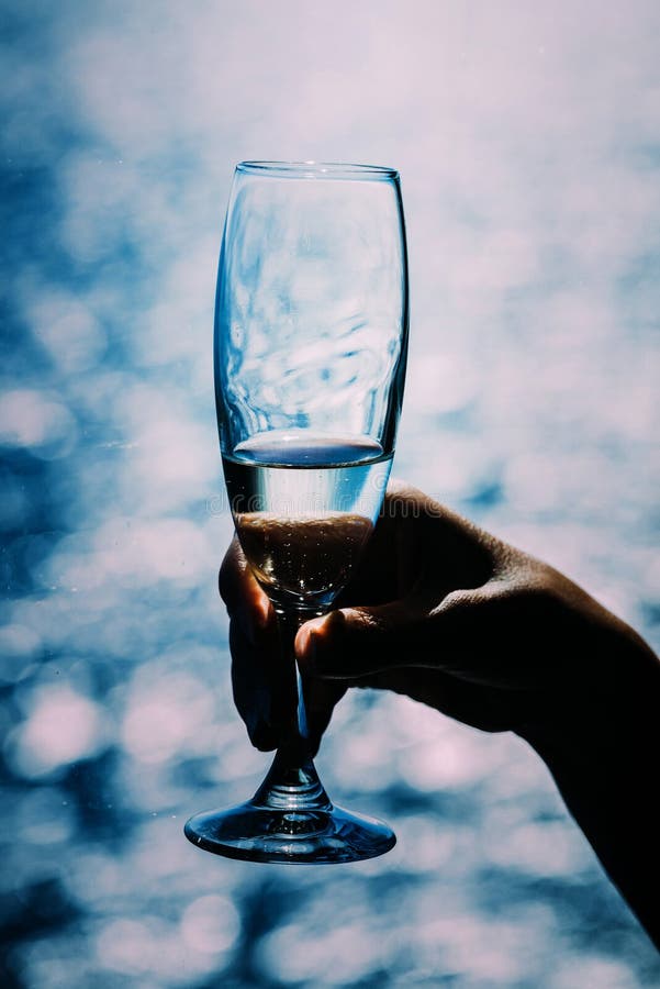 Stemmed Glass of Clear Liquid in a Toast Stock Photo - Image of revelry ...