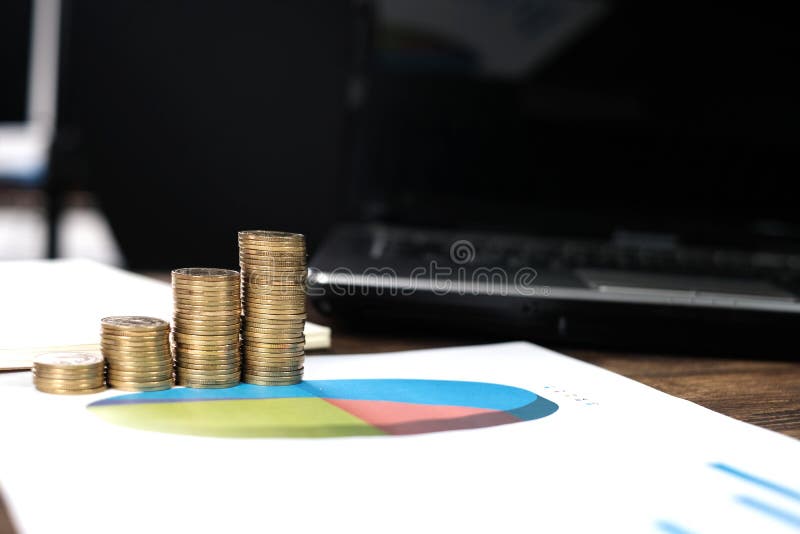 Step of Coins Stacks with Notebook Laptop Computer and Financial Stock ...
