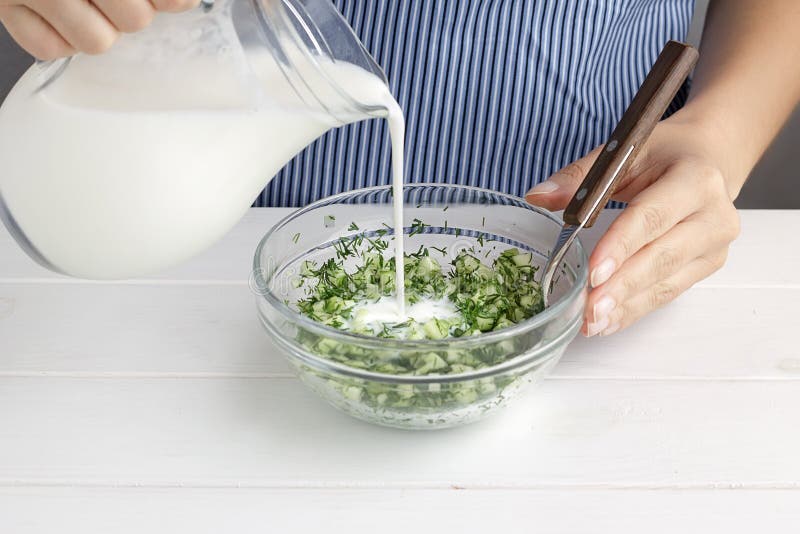 Step by Step Recipe for Tarator. Hands Pour Yogurt into a Bowl with ...