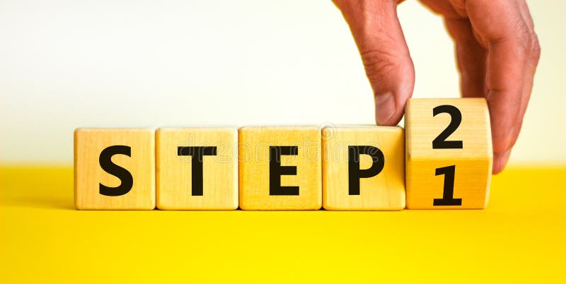 Step 1 or 2 Symbol. Businessman Turns a Wooden Cube and Changes Words ...