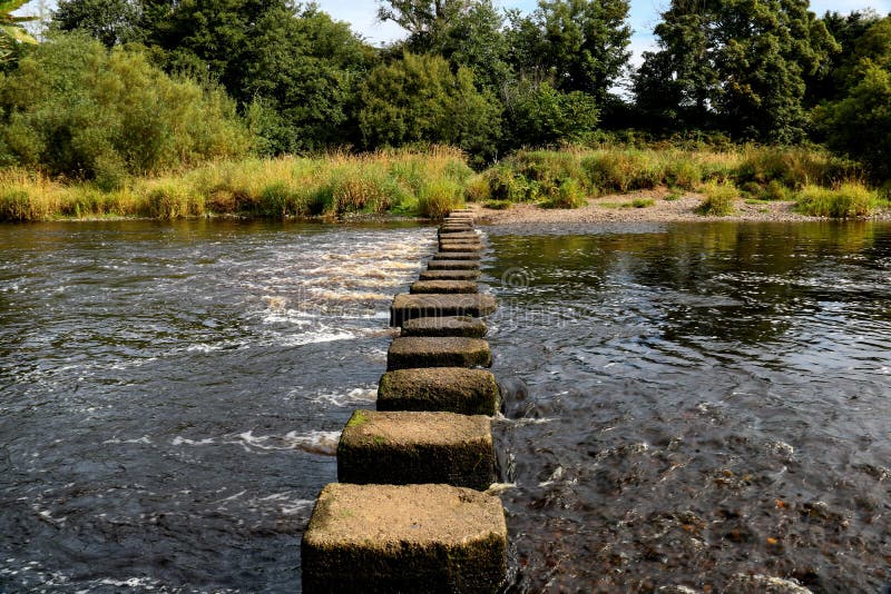 Stepping Stones Across a Flowing Rural River Stock Photo - Image of ...