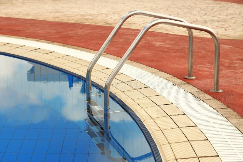 Steps in blue water pool stock image. Image of chrome - 83474113