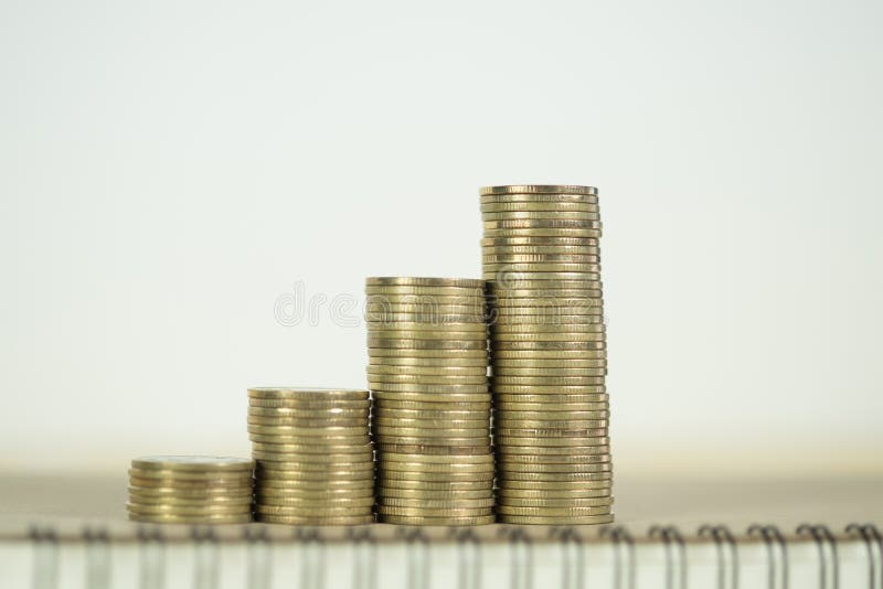 Steps of Coins Stack with Notebook Paper on Wooden Working Table Stock ...