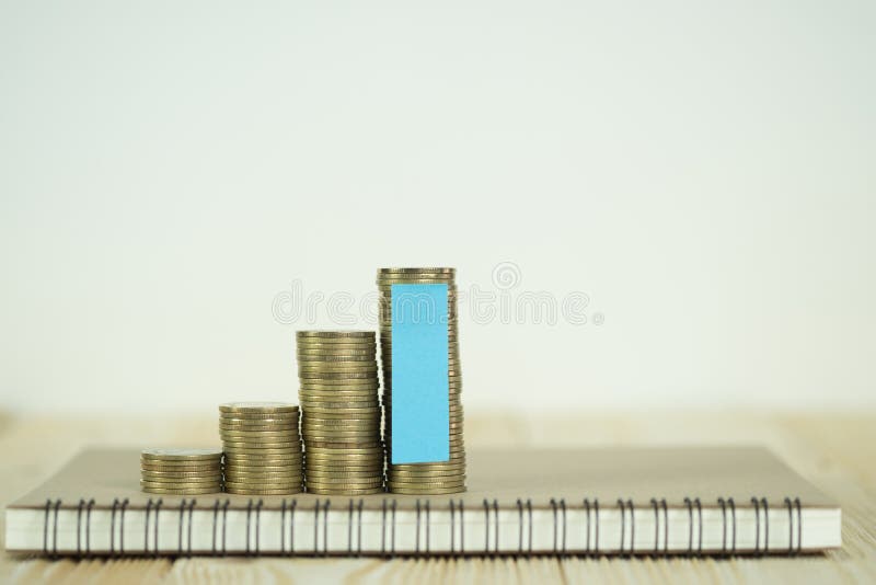 Steps of Coins Stack with Notebook Paper on Wooden Working Table Stock ...