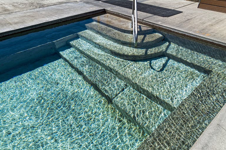 Steps Lead Gently into a Shallow Pool with Rippled Patterns on the ...