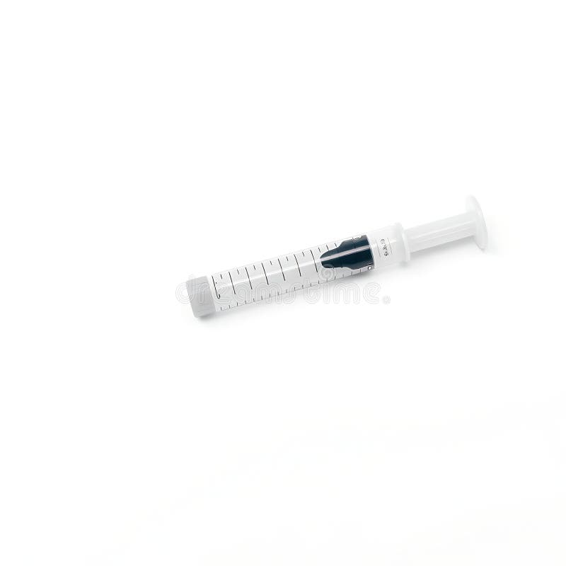A Sterile Syringe with a Capped Needle Lying Flat on a White Surface ...