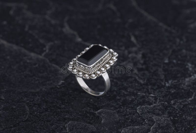 Sterling Silver Ring on Black Stone Background Stock Photo - Image of ...
