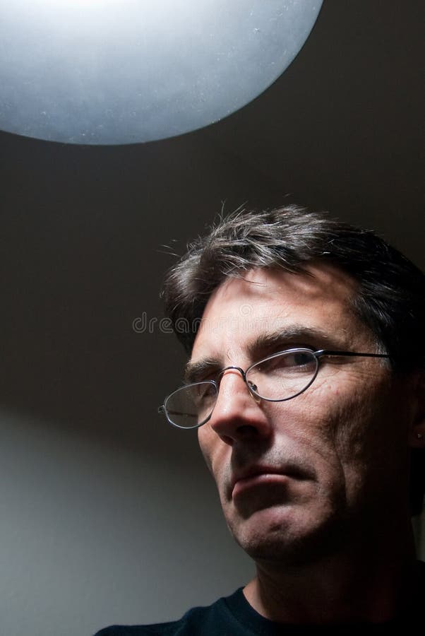 Stern man under light stock photo. Image of illuminated - 9436438