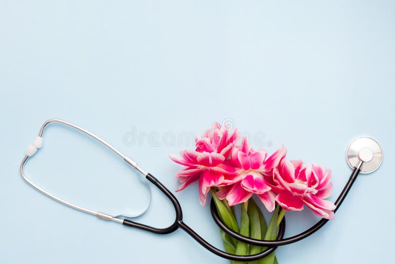 A Stethoscope on Blue Background with a Spring Flowers Stock Image ...