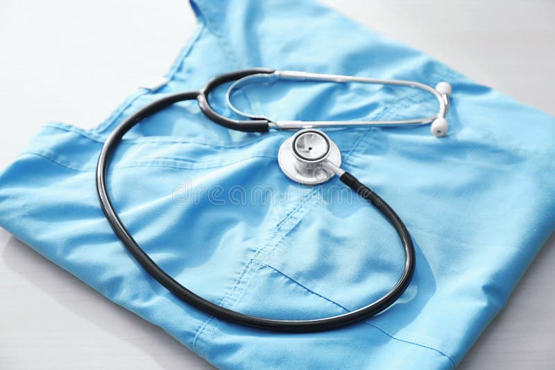 Stethoscope with Blue Doctor S Uniform on Table Stock Image - Image of ...