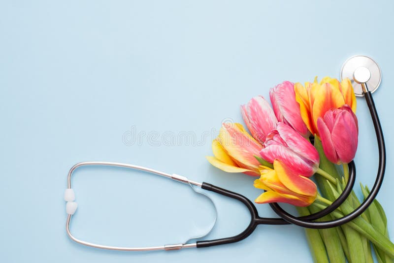 A Stethoscope on Blue Background with a Spring Flowers Stock Image ...
