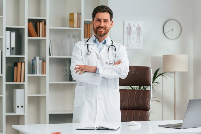 With Stethoscope. Doctor in Formal Clothes is Working in the Cabinet ...