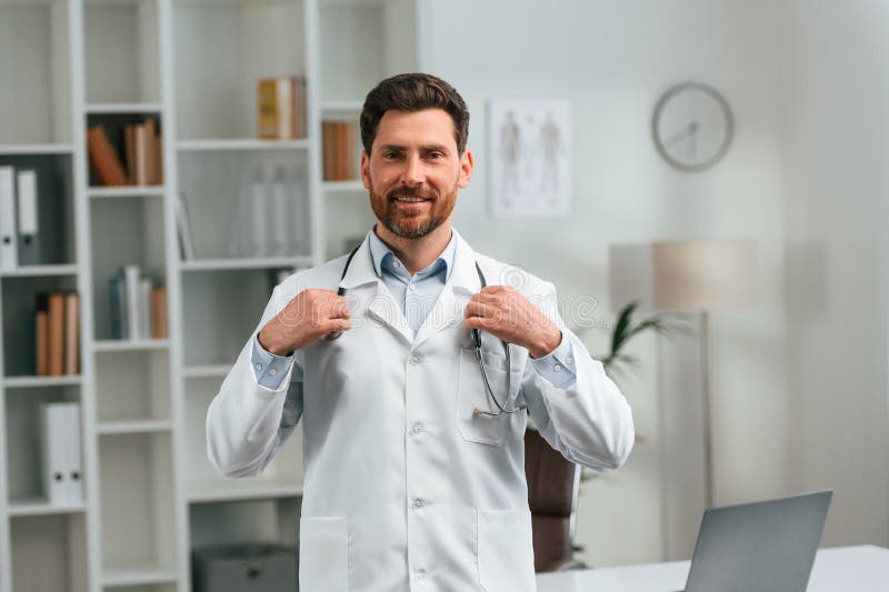 With Stethoscope. Doctor in Formal Clothes is Working in the Cabinet ...