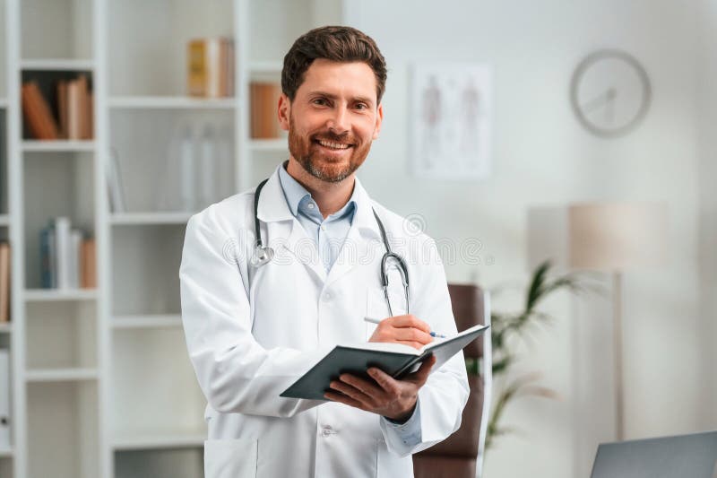 With Stethoscope. Doctor in Formal Clothes is Working in the Cabinet ...