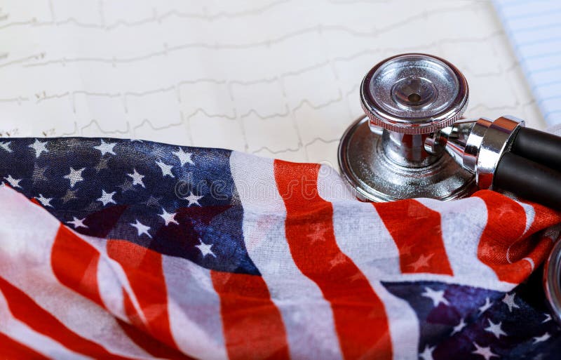 Stethoscope and ECG Cardiogram on a Paper on American National Flag ...