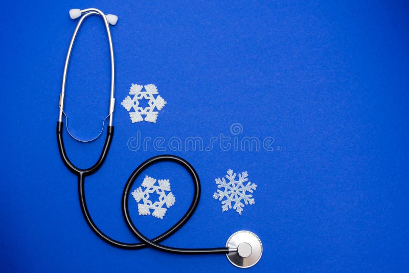 A Stethoscope on Blue Background with a Spring Flowers Stock Image ...