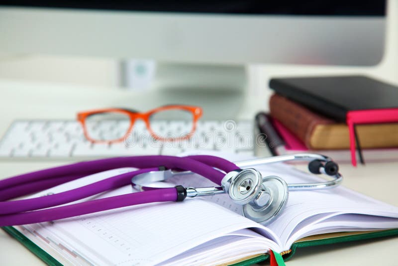 Stethoscope Lying on a Notebook Computer in the Background and Books ...