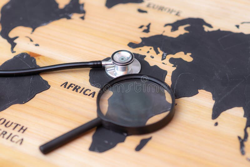 Stethoscope Magnifying Glass on Wooden World Map Background. Selective ...