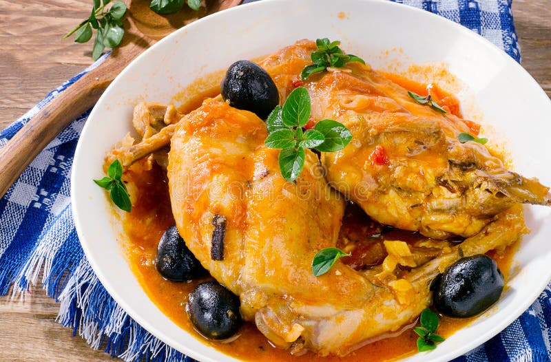 Stewed Rabbit Legs with Black Olives and Herbs Leaves. Stock Photo ...