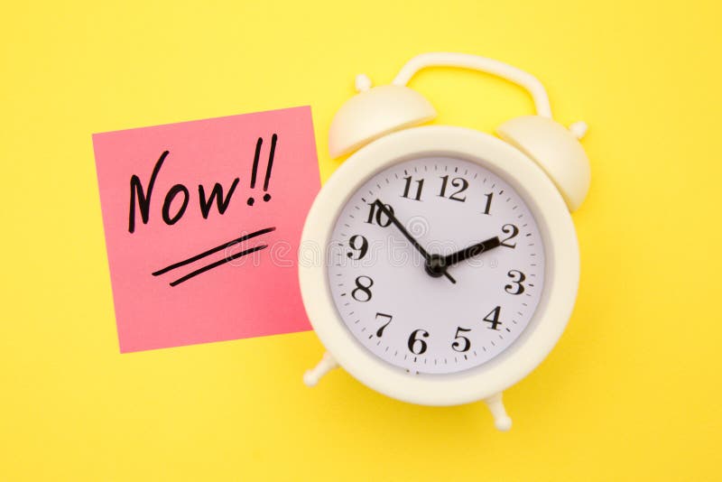Sticker with Handwriting the Word NOW on Alarm Clock on Yellow ...