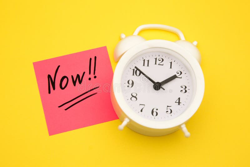 Sticker with Handwriting the Word NOW on Alarm Clock on Dark Blue ...