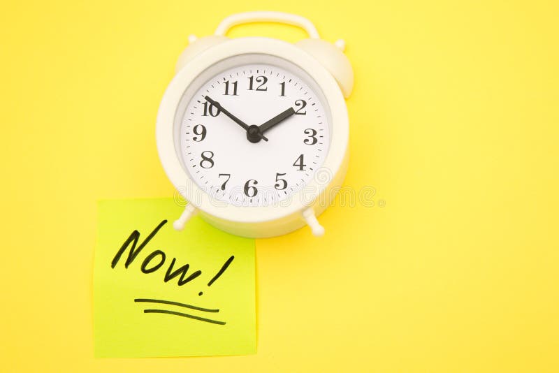 Sticker with Handwriting the Word NOW on Alarm Clock on Dark Blue ...