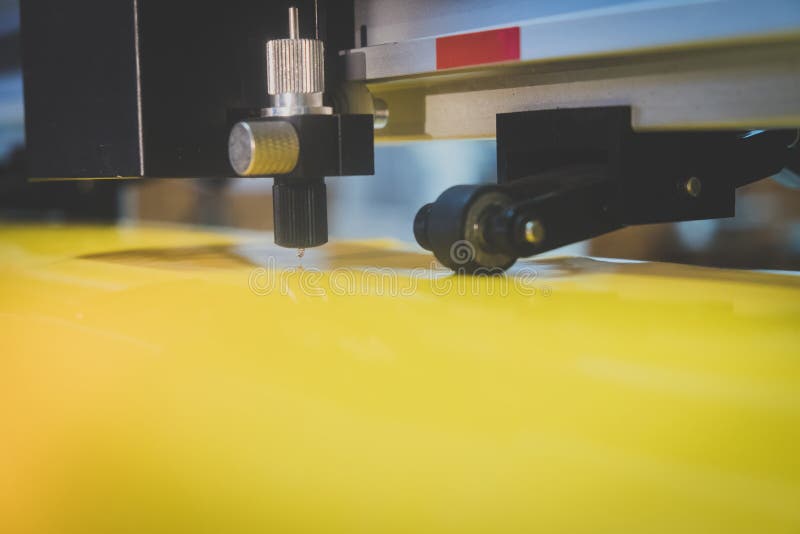 Sticker Machine is Working. Cut Down the Yellow Sticker Stock Image ...