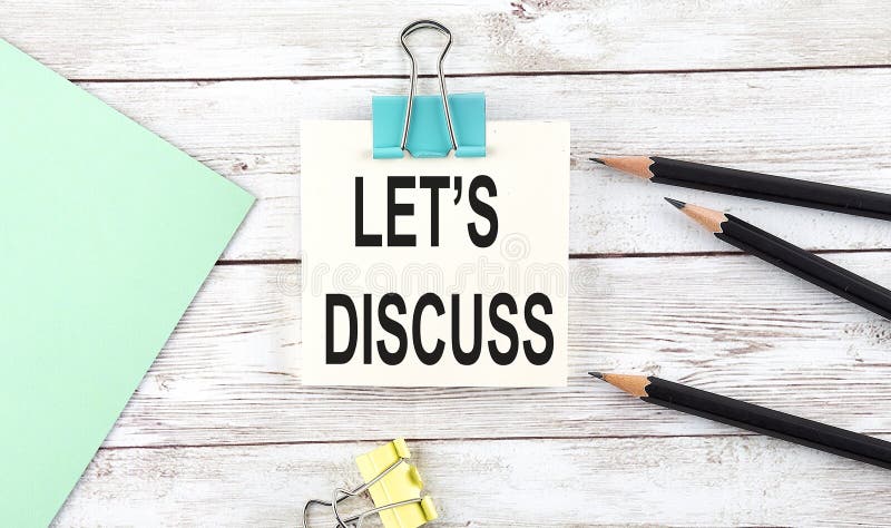 Stickers with Pencils and Notebook with Text LET`S DISCUSS on Wooden ...
