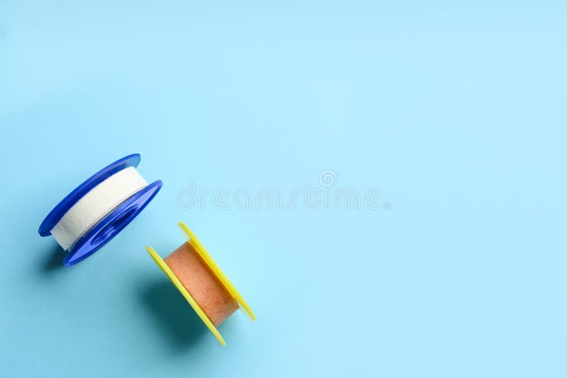 Sticking Plaster Rolls on Light Blue Background, Flat Lay. Space for ...