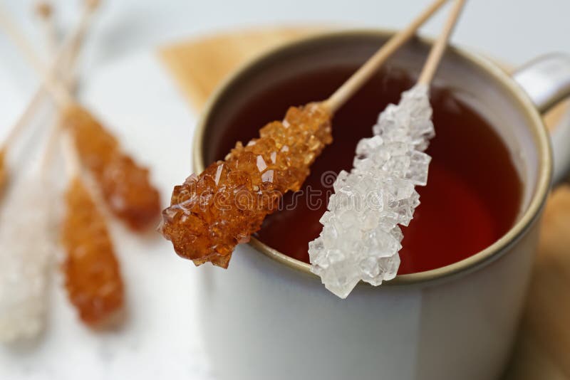 Sticks with Sugar Crystals and Cup of Tea on Table, Closeup Stock Image ...