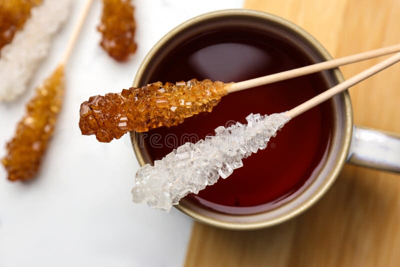 Sticks with Sugar Crystals and Cup of Tea on Table, Top View Stock ...