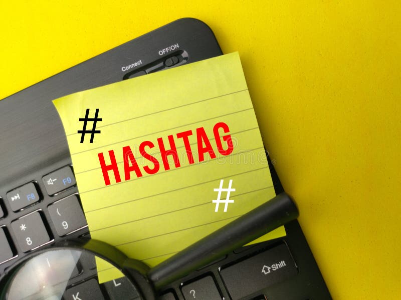 Word Hashtag Composed with Multicolored Heart Stones Over Green Sand ...