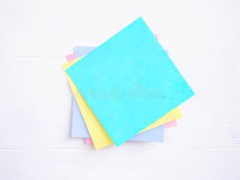 Sticky Note Post-it Stack on a White Wooden. Blank Space for Text and ...