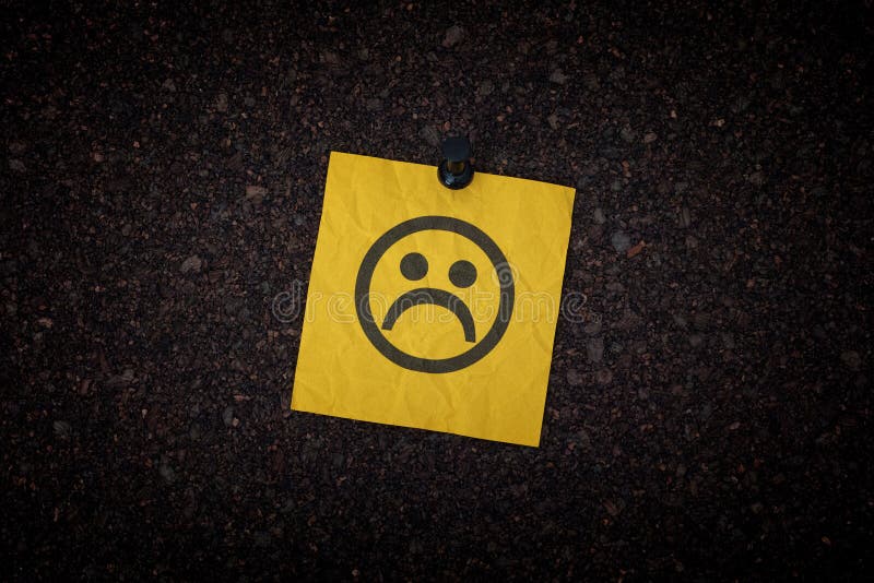 A Sticky Note with a Sad Face on it Pinned To a Corkboard Stock Photo ...