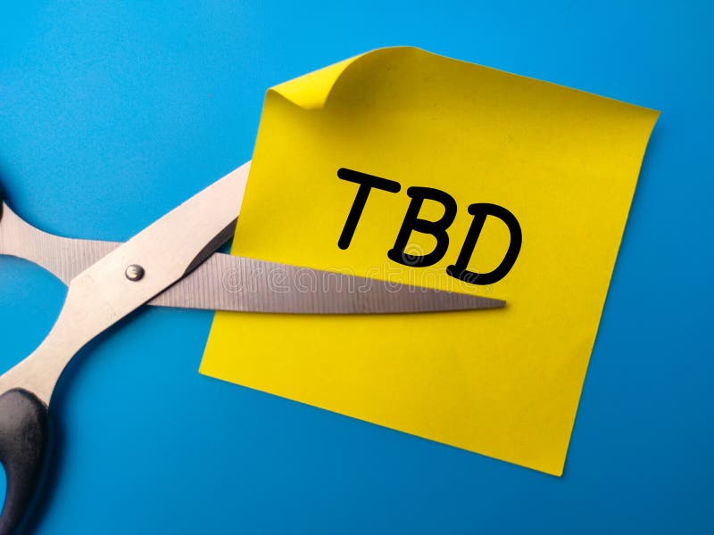 Sticky Note and Scissors with the Word TBD To Be Determined Stock Photo ...