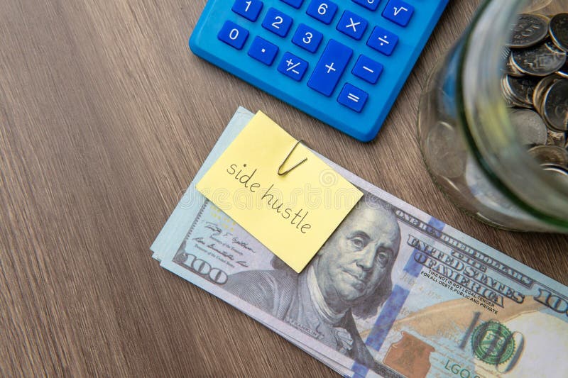 A Sticky Note with the Words "side Hustle" on Top of a Stack of US ...