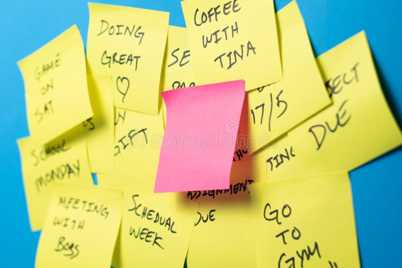 Sticky Notes on a Blue Wall with Pink Note in Center Stock Photo ...
